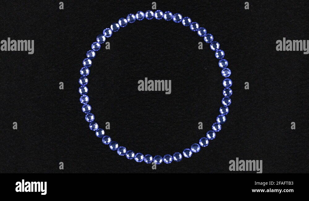 Rotation of a circle made of blue rhinestones, the symbol of infinity ...