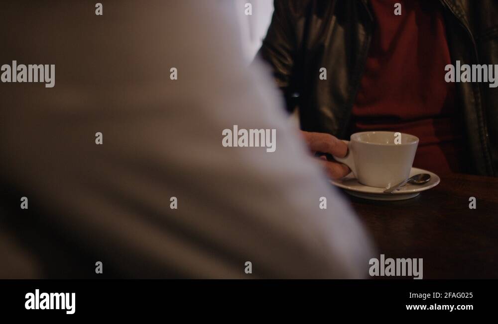 Two older men in conversation over some coffee in a coffee shop Stock ...
