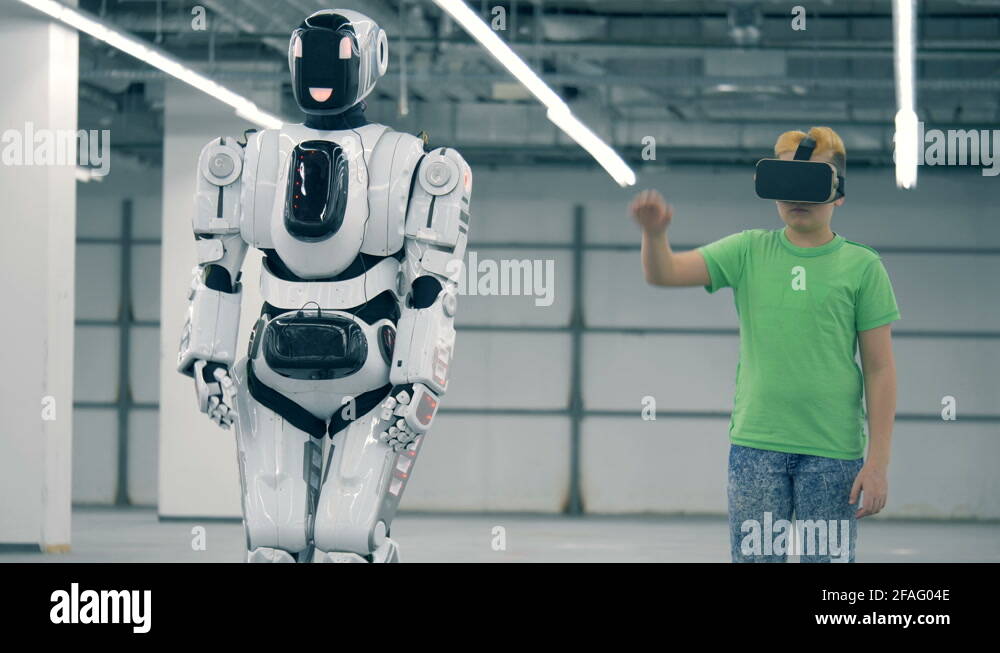 A boy and a robot moving hands, close up. Modern cyborg with children ...