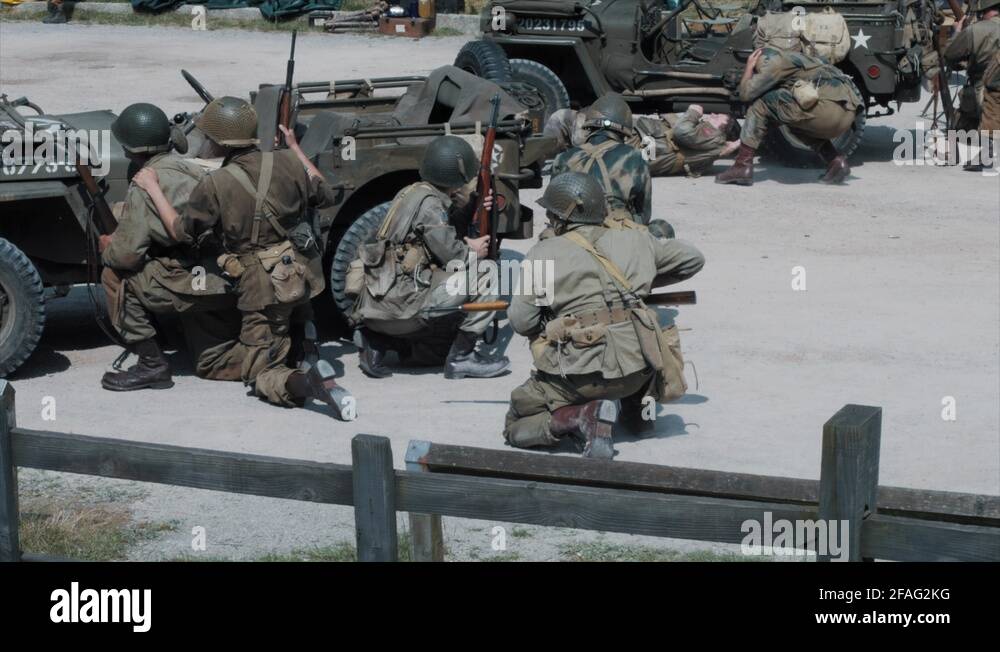 World war two re-enactment battle. American GI army soldiers firing ...
