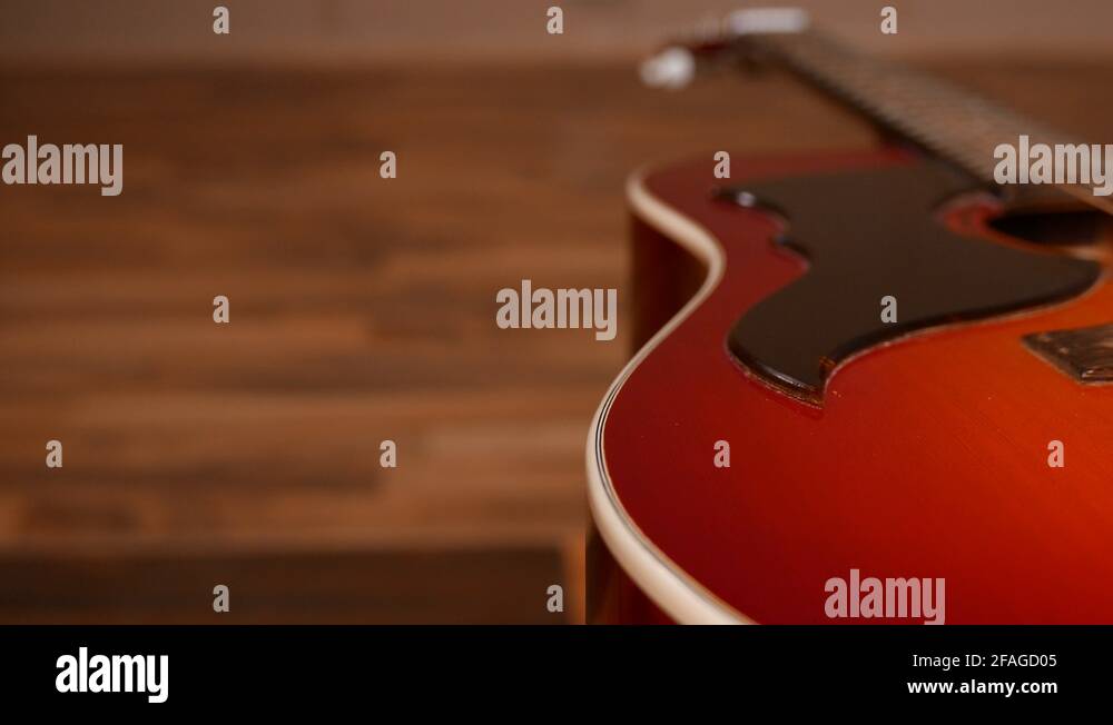 Shocking, unexpected reveal of a damage on a red acoustic guitar with a ...