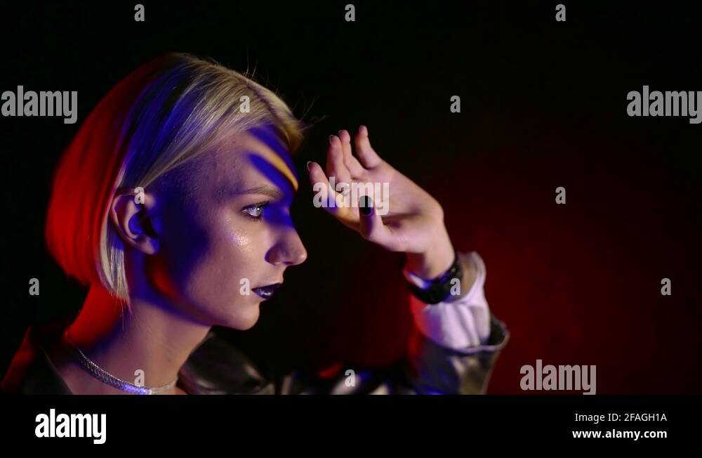 female model is covering her face by hand from bright light of soffit ...