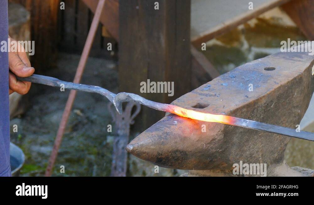 The iron is forging while it is hot. Blacksmith manufactures wrought ...