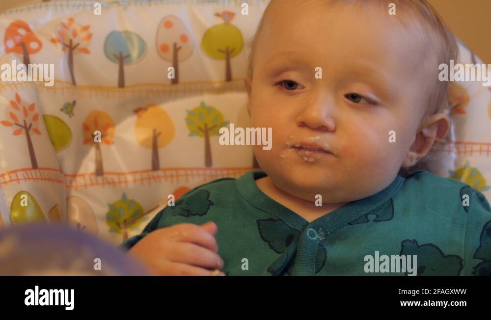 Parent feeding his baby using spoon Stock Video Footage - Alamy