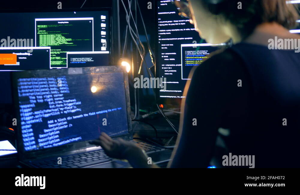 A hacker typing on a laptop, cracking system, back view Stock Video ...