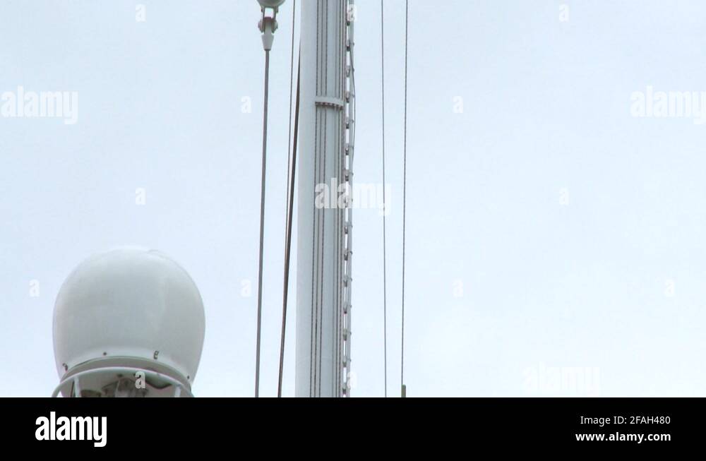 workers assemble scaffolding on ship mast in shipyard dry dock slow ...