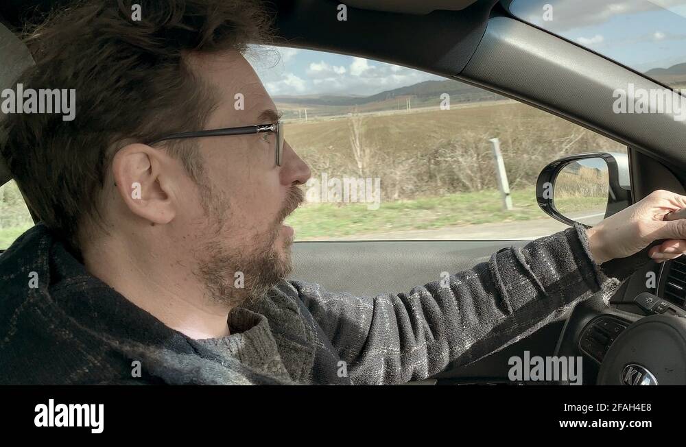 Man driving car getting angry with car passing fast dangerous closeup ...