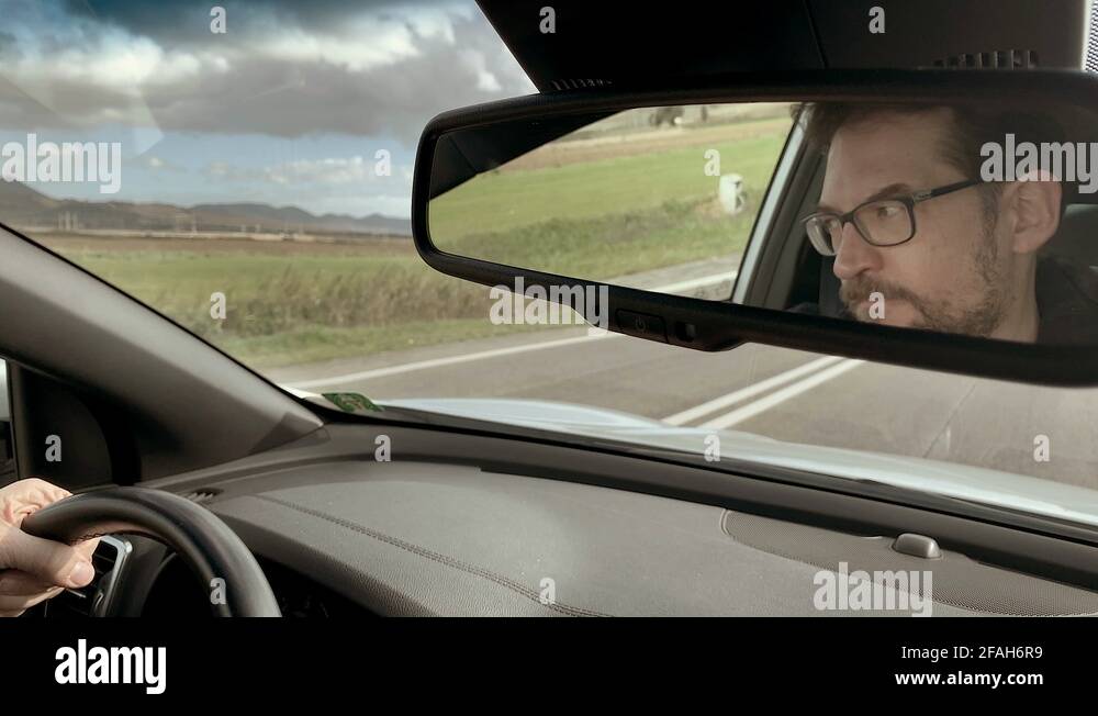 Man driving car getting angry with car passing fast dangerous Stock ...