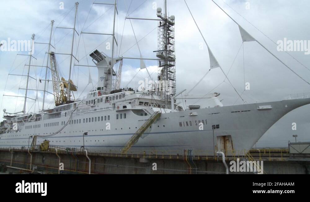 workers assemble scaffolding on ship mast in shipyard dry dock slow ...