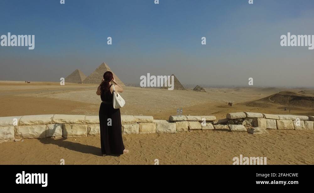 Camera going towards a panoramic view of the Giza pyramid complex while ...