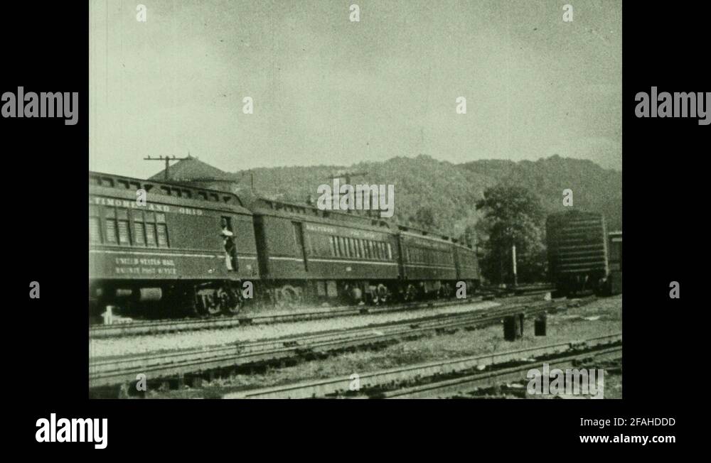 1950s: UNITED STATES: train carriages move slowly along line from ...