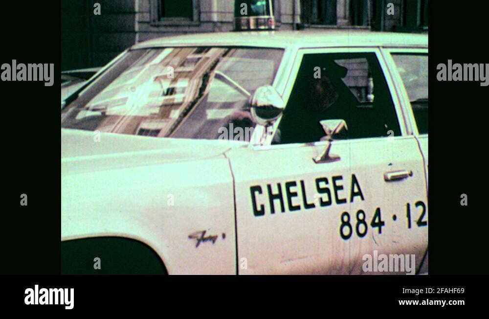 1970s: UNITED STATES: Chelsea police car. Police officer speaks to ...