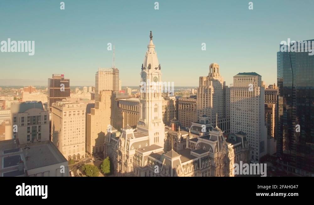 Flying backwards, showing the City hall in Philadelphia during golden ...