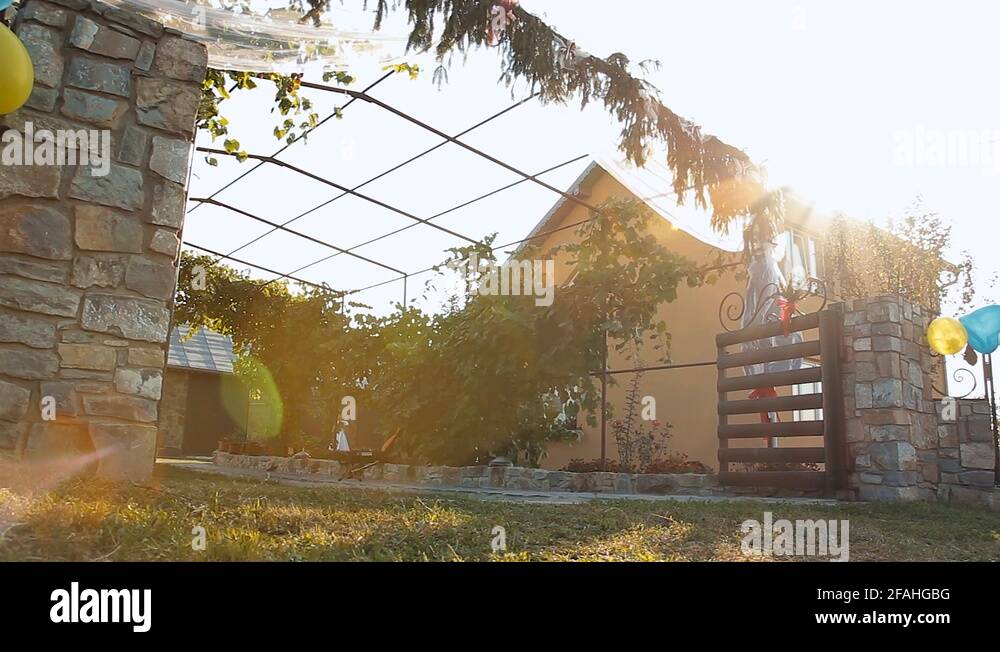 Sun rays around the gate of the house Stock Video Footage - Alamy