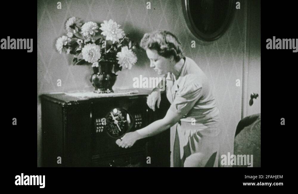 1940s: Woman turns knob on radio. Family sits at dining table and ...
