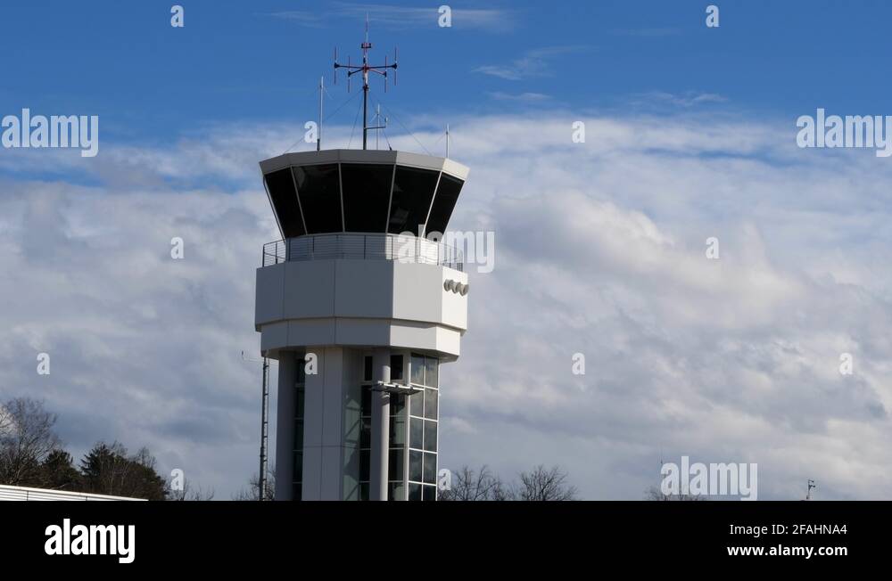 An isolated air traffic control (ATC) tower and antenna to a backdrop ...