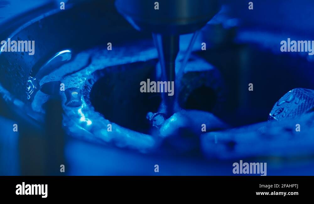 Dental milling machine carving out shape of human teeth from metal ...