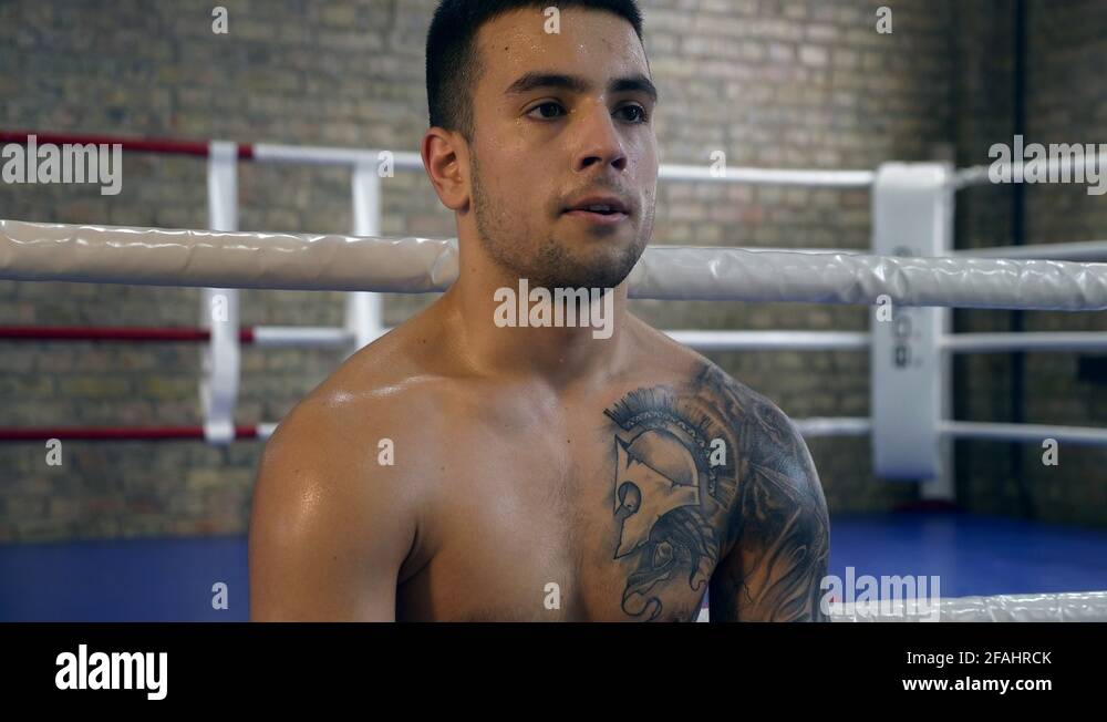 Close-up Muscular Professional Male Boxer Resting on Boxing Ring After ...