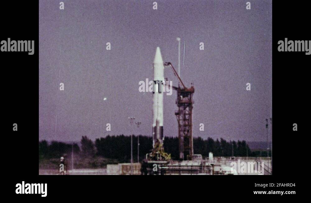 1960s: Rocket prepares for liftoff from the launch pad, smoke trail ...