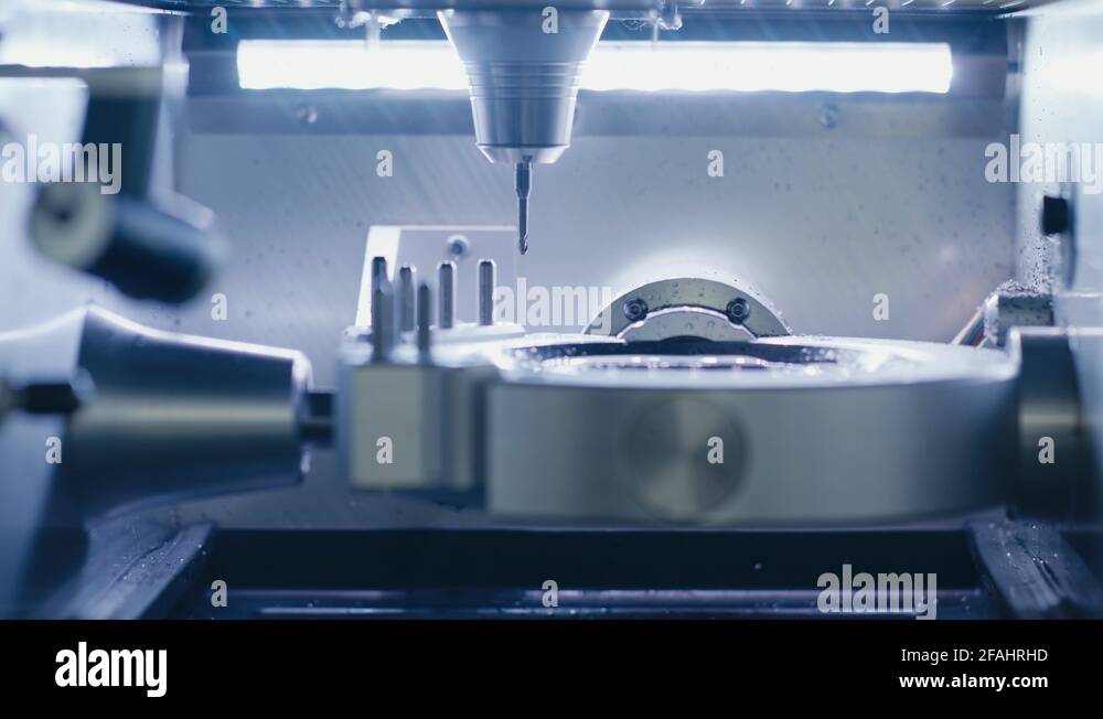 Dental milling machine carving out shape of human teeth from metal ...