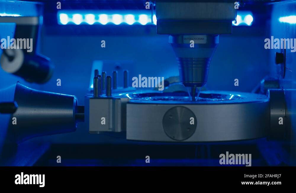 Dental milling machine carving out shape of human teeth from metal ...