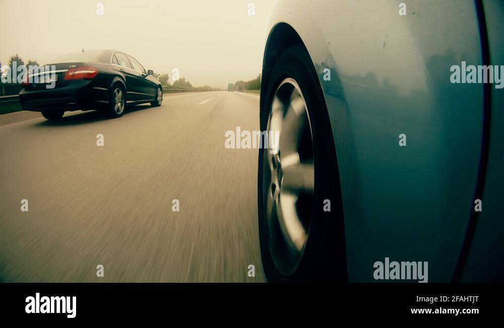 A highly stylized clip of a car speeding down the highway on the German ...