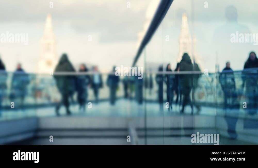 People walking through glass reflection. Business people going to ...