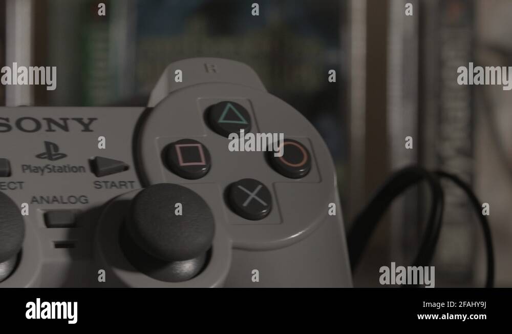 Front of Vintage Playstation Console and Controllers with Games in ...