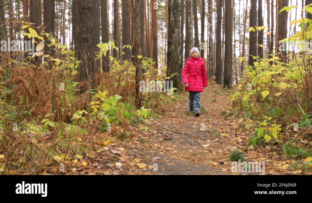 Little girl walking along a path in park Stock Video Footage - Alamy