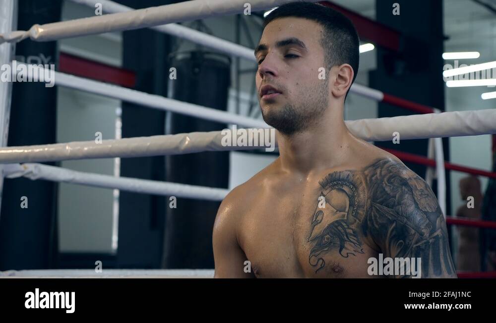 Close-up Muscular Professional Male Boxer Resting on Boxing Ring After ...