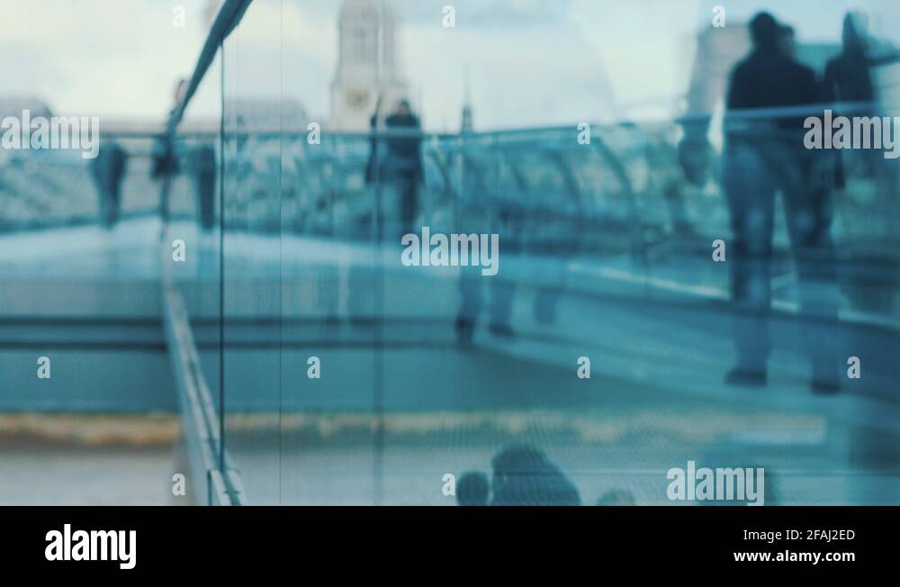 People walking through glass reflection. Business people going to ...