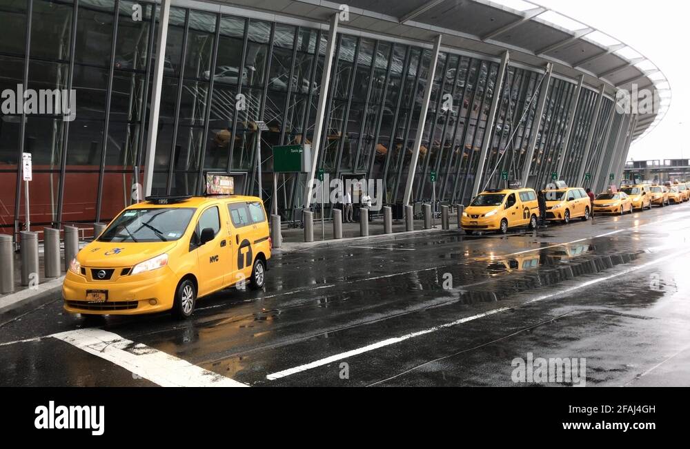 Taxi line parked outside of JFK on rainy day 4k Stock Video Footage - Alamy