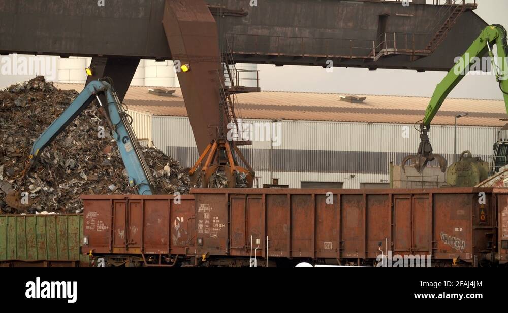 Crane picking up metal scrap into a ship, recycling company in Germany ...