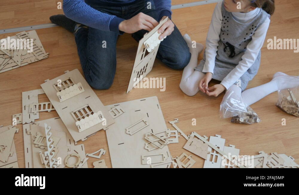Little girl with father building wooden toy house Stock Video Footage ...