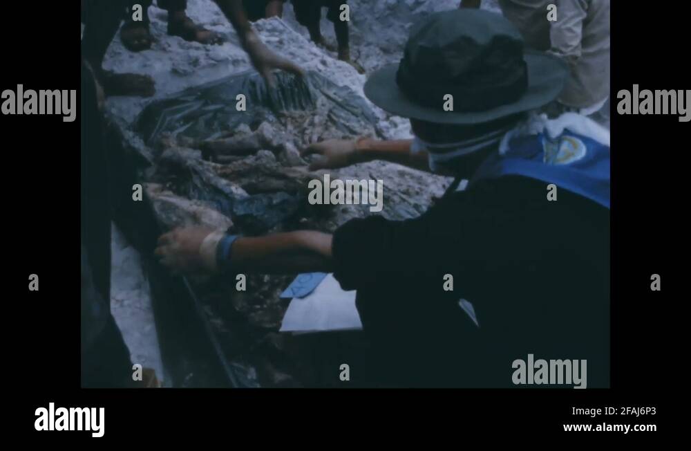 Workers conduct digging and packing the remains of the dead body - 1969 ...