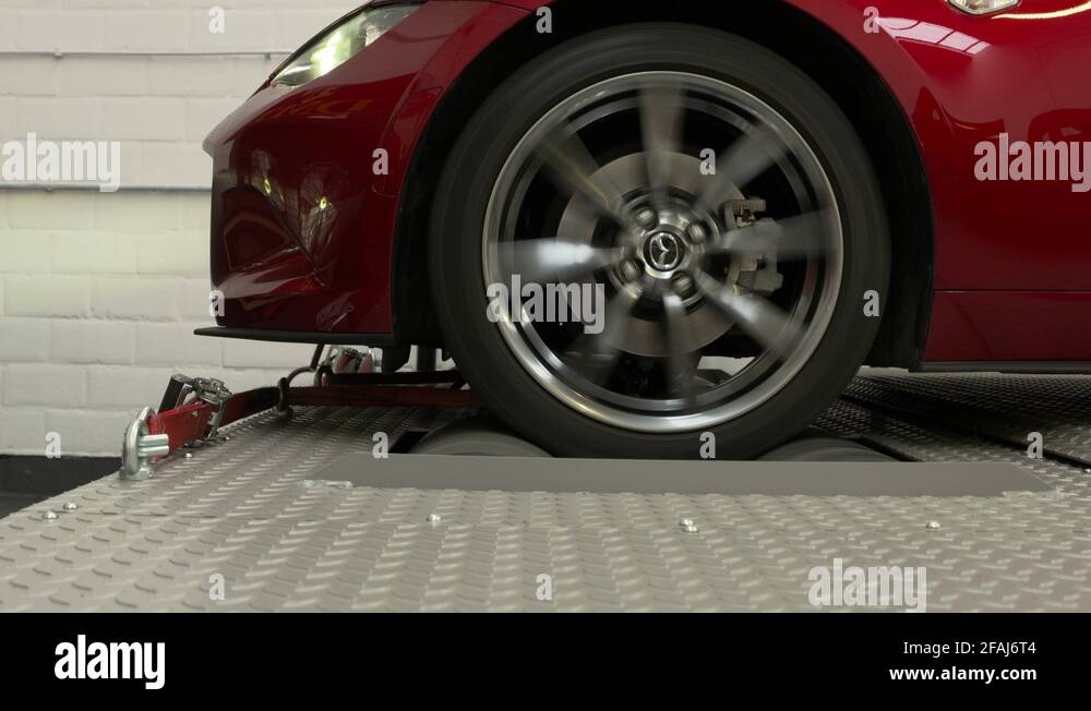 Close ups from a car on a rolling road or dynamometer. Being tested ...
