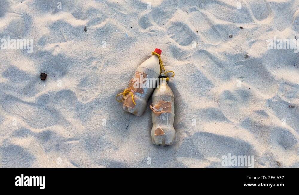 Coca Cola Coke Plastic Bottles Lying In The Sand. Environment ...