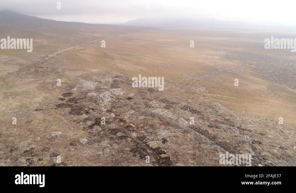 Pollution with a lot of Waste in a nice desert landscape. Aerial from ...