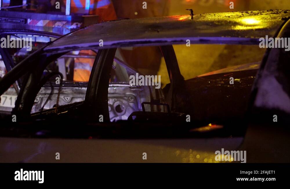 Wrecked car in a accident, rear end window with firefighter in the ...