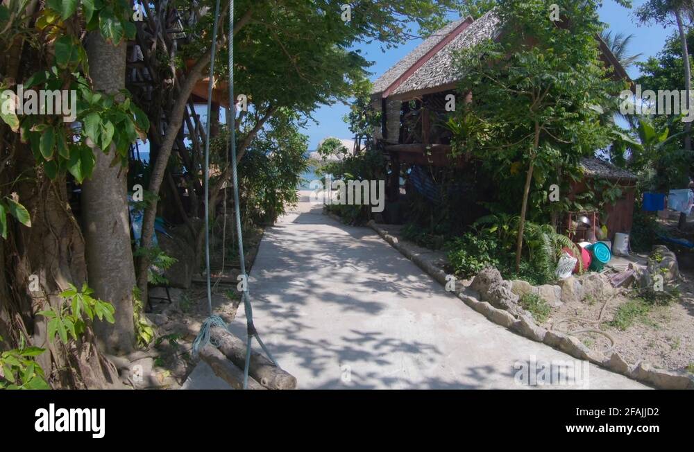 Public beach access walkway between buildings on stilts with thatched ...
