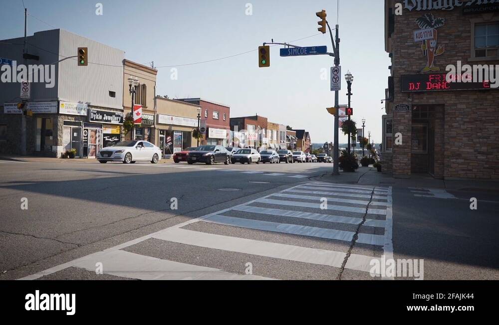 Cars stopped at an intersection on a street in a small town Stock Video ...
