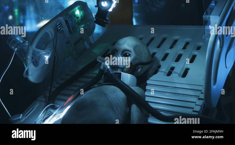 Alien lies beneath the artificial respiration apparatus, his breath is ...