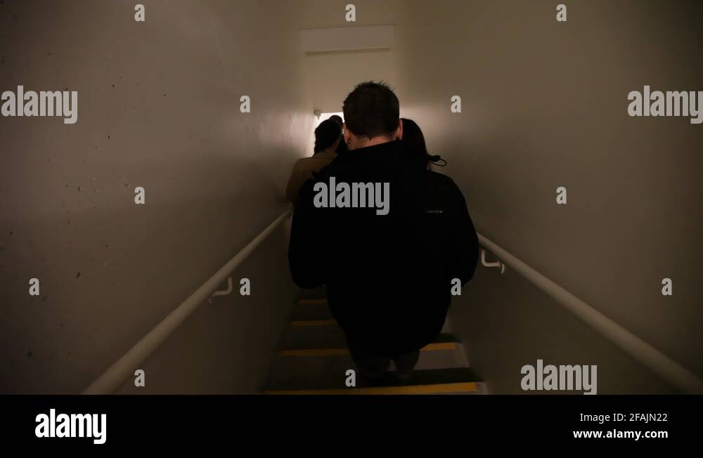 People walking down a dark stairwell Stock Video Footage - Alamy