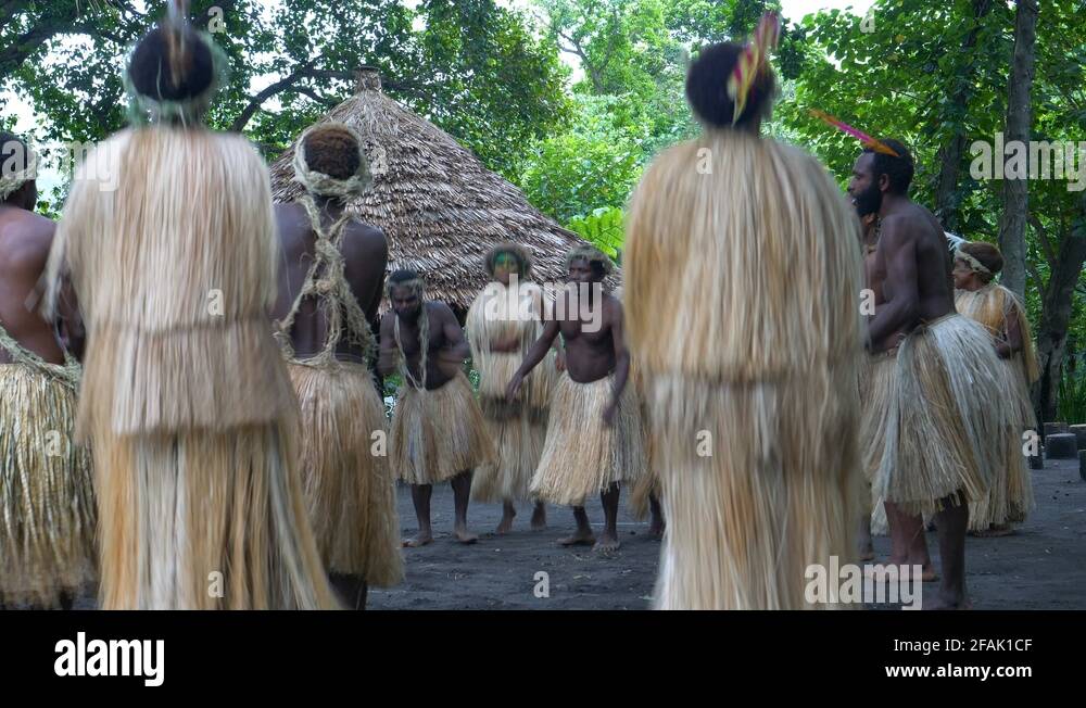 Indigenous black people in traditional outfits dancing and stomping ...