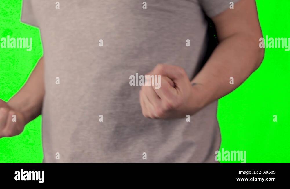 Man Powering Up in front of green screen Stock Video Footage - Alamy