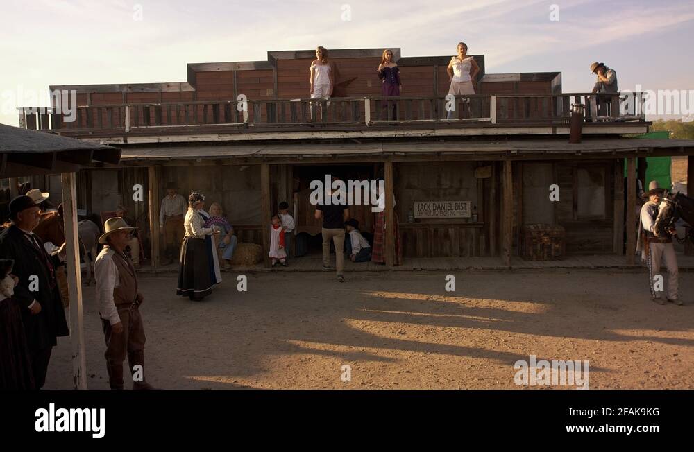Period style reenactment of wild west scene in front of saloon. Gun ...