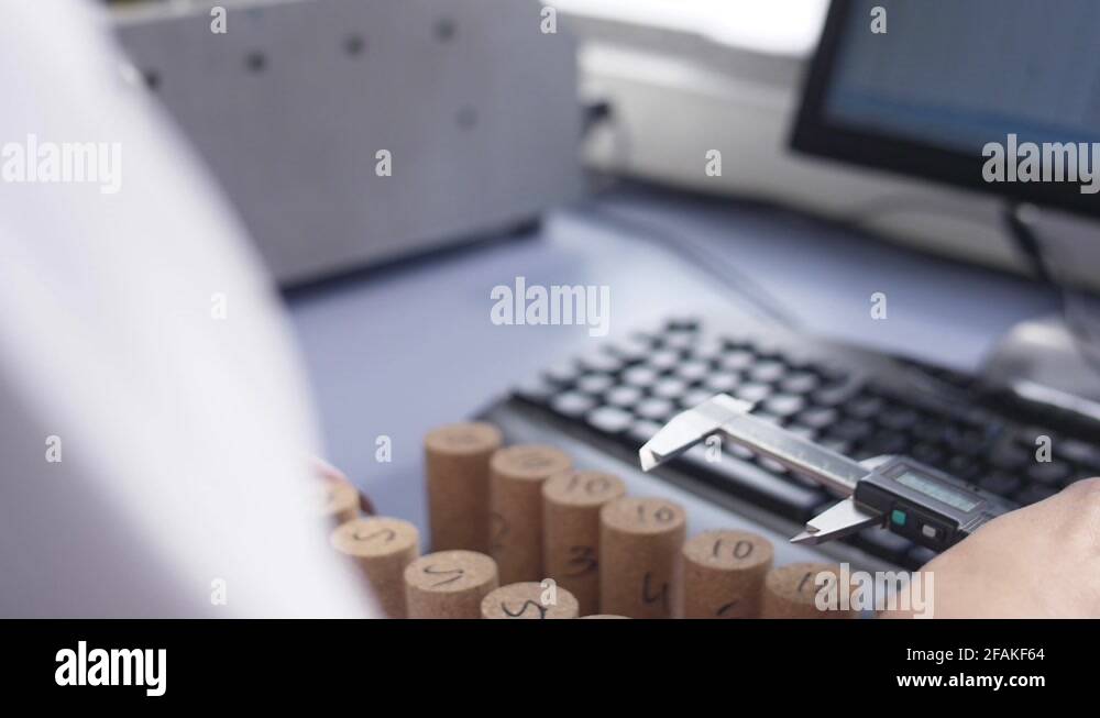 measuring digital pachometer of cork stopper sample in laboratory slow ...