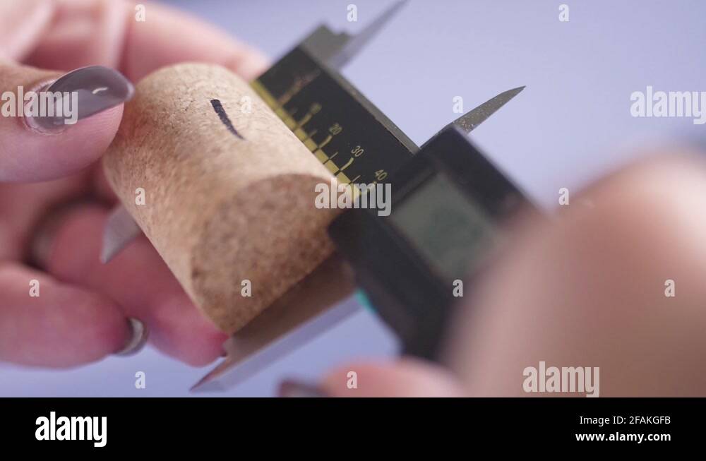 measuring digital pachometer of cork stopper sample in laboratory slow ...