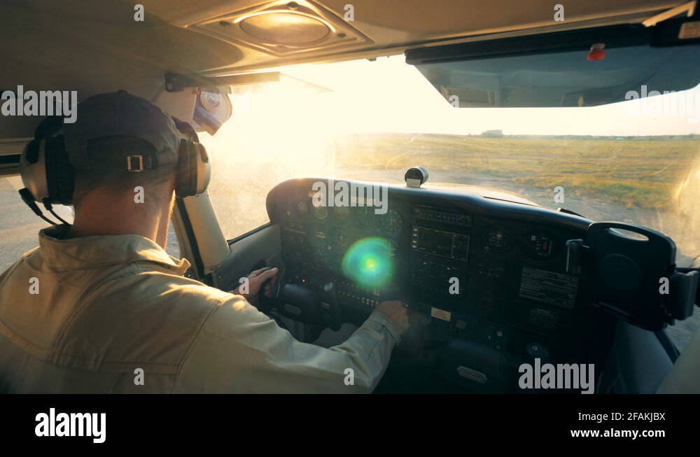 Man piloting an airplane on an airfield, back view Stock Video Footage ...