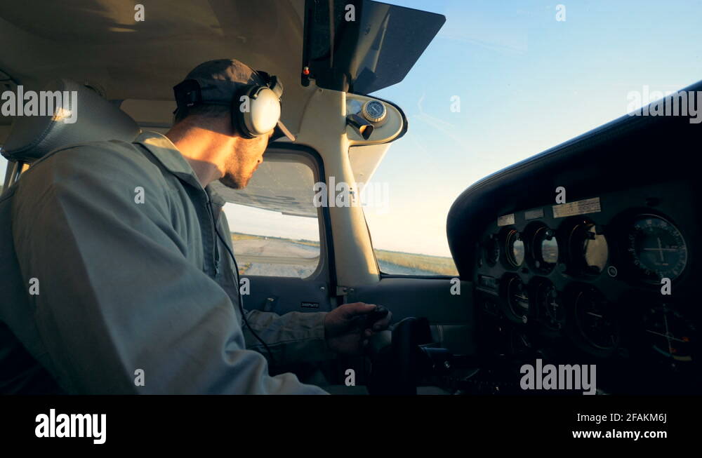Male aviator pilots a plane in a cockpit, side view Stock Video Footage ...